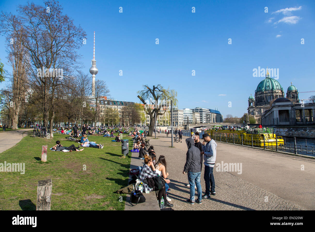 James Simon Park, along river Spree, people enjoying the spring sun in ...
