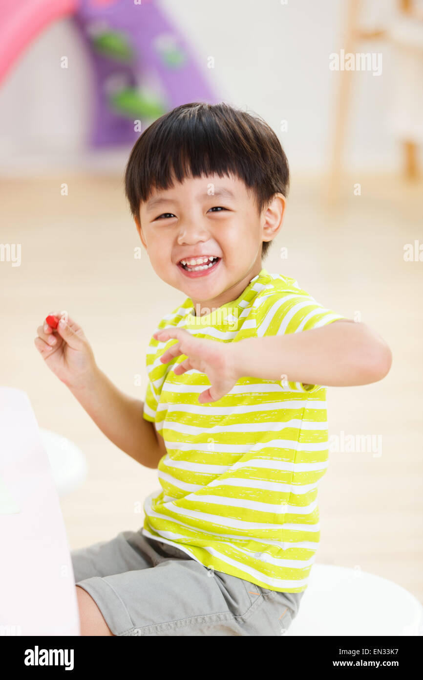 Lovely boy sat beside the table Stock Photo - Alamy