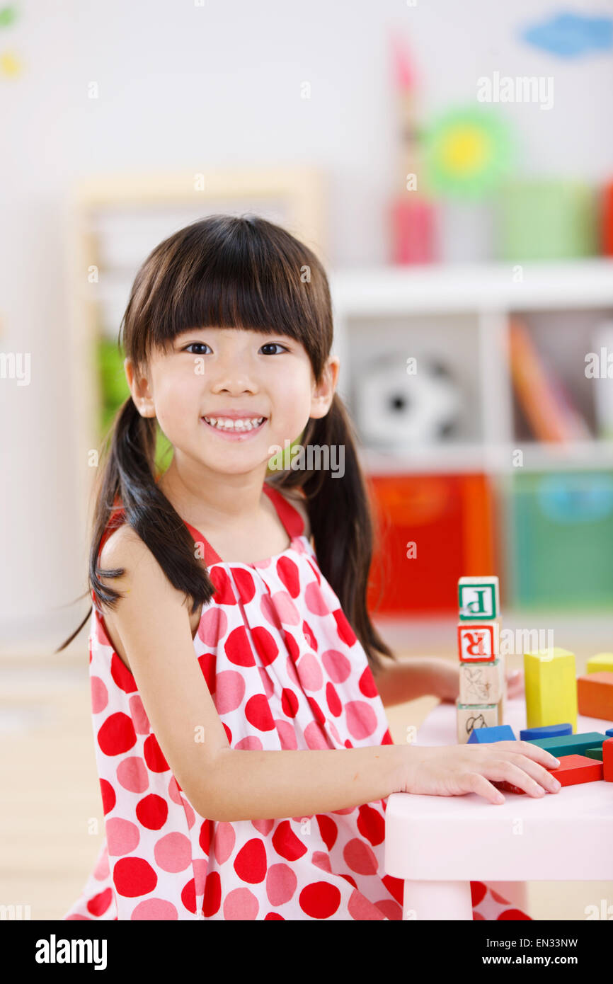 Cute little girl playing in the kindergarten Stock Photo - Alamy