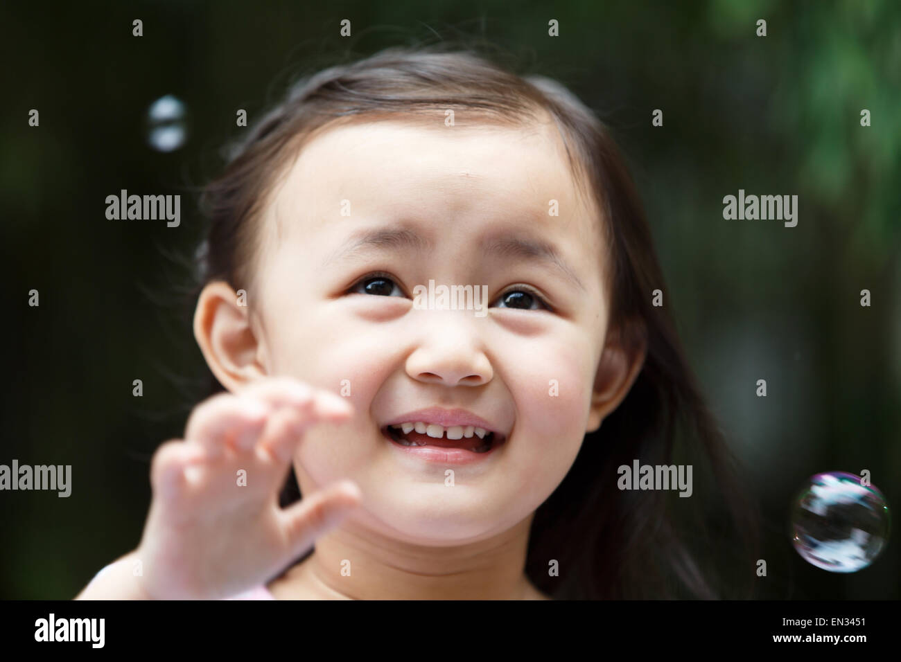 Cute little girls is playing outside Stock Photo - Alamy