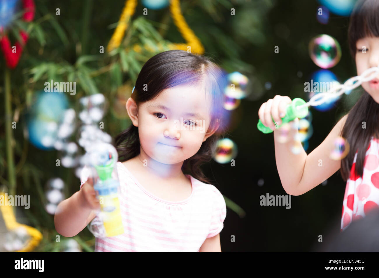Cute little girls is playing outside Stock Photo - Alamy