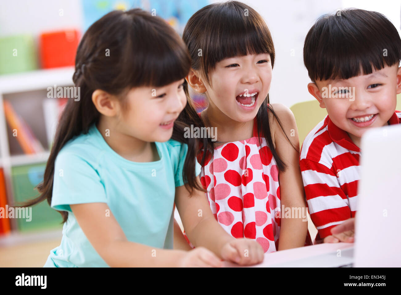 In the kindergarten children are using the computer Stock Photo - Alamy