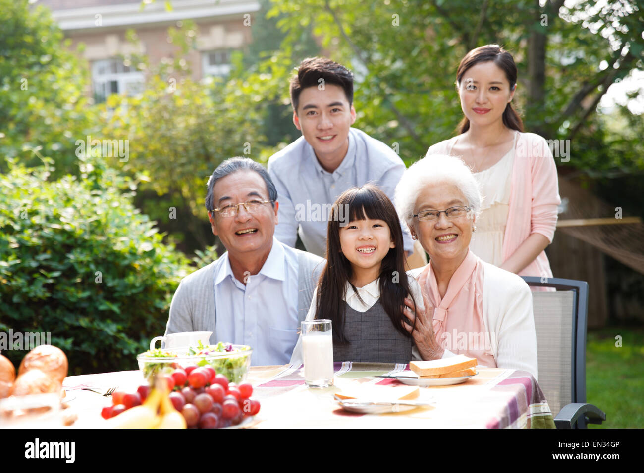 Happy families eat breakfast outdoors Stock Photo - Alamy