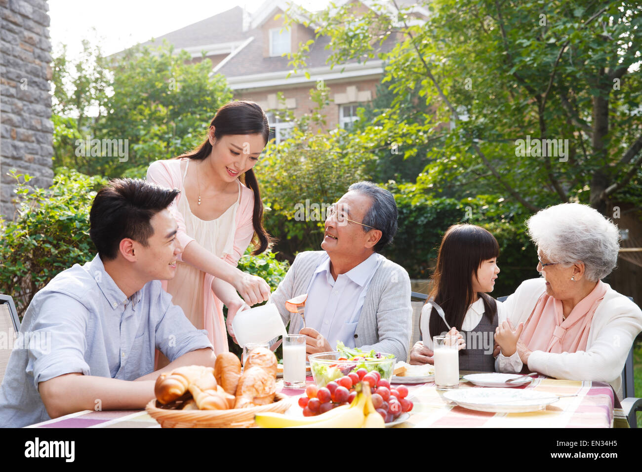 Happy families eat breakfast outdoors Stock Photo - Alamy