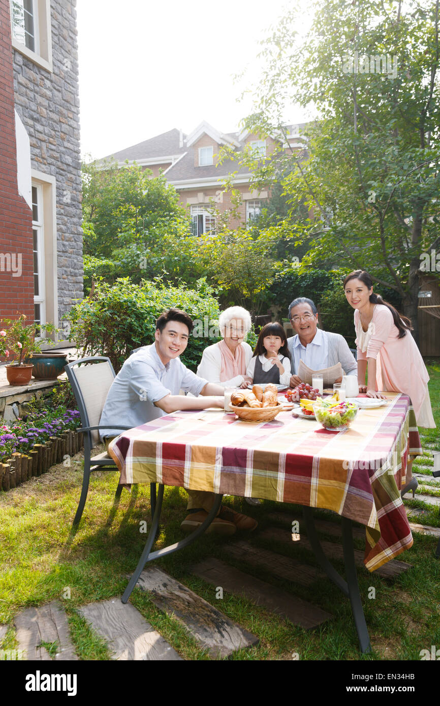 Happy families eat breakfast outdoors Stock Photo - Alamy