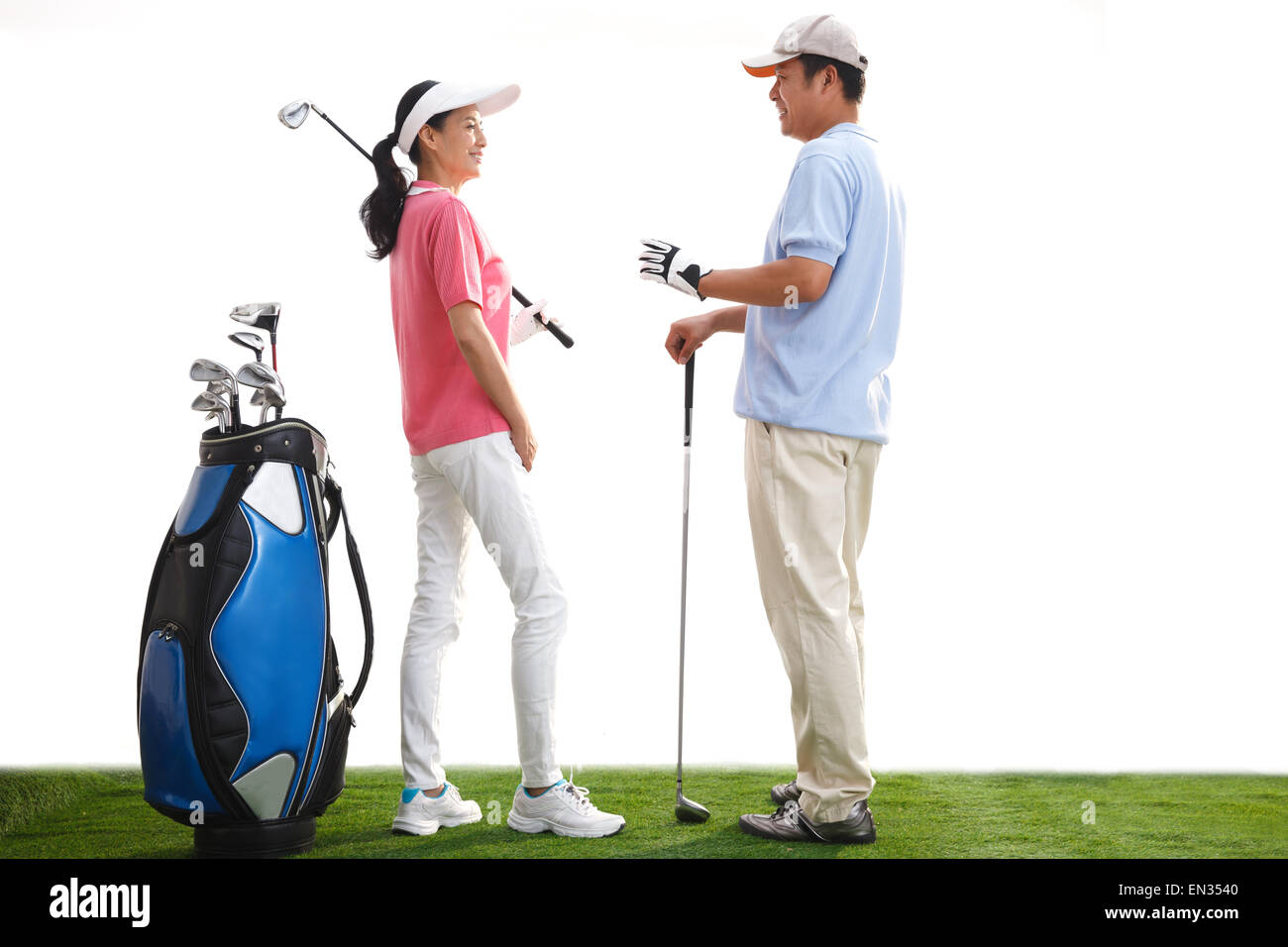 A middle-aged couple playing golf Stock Photo - Alamy