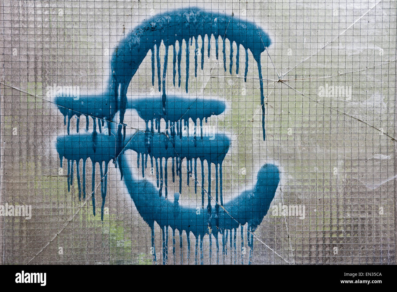 Euro sign, blue, sprayed onto glass, melting away Stock Photo - Alamy