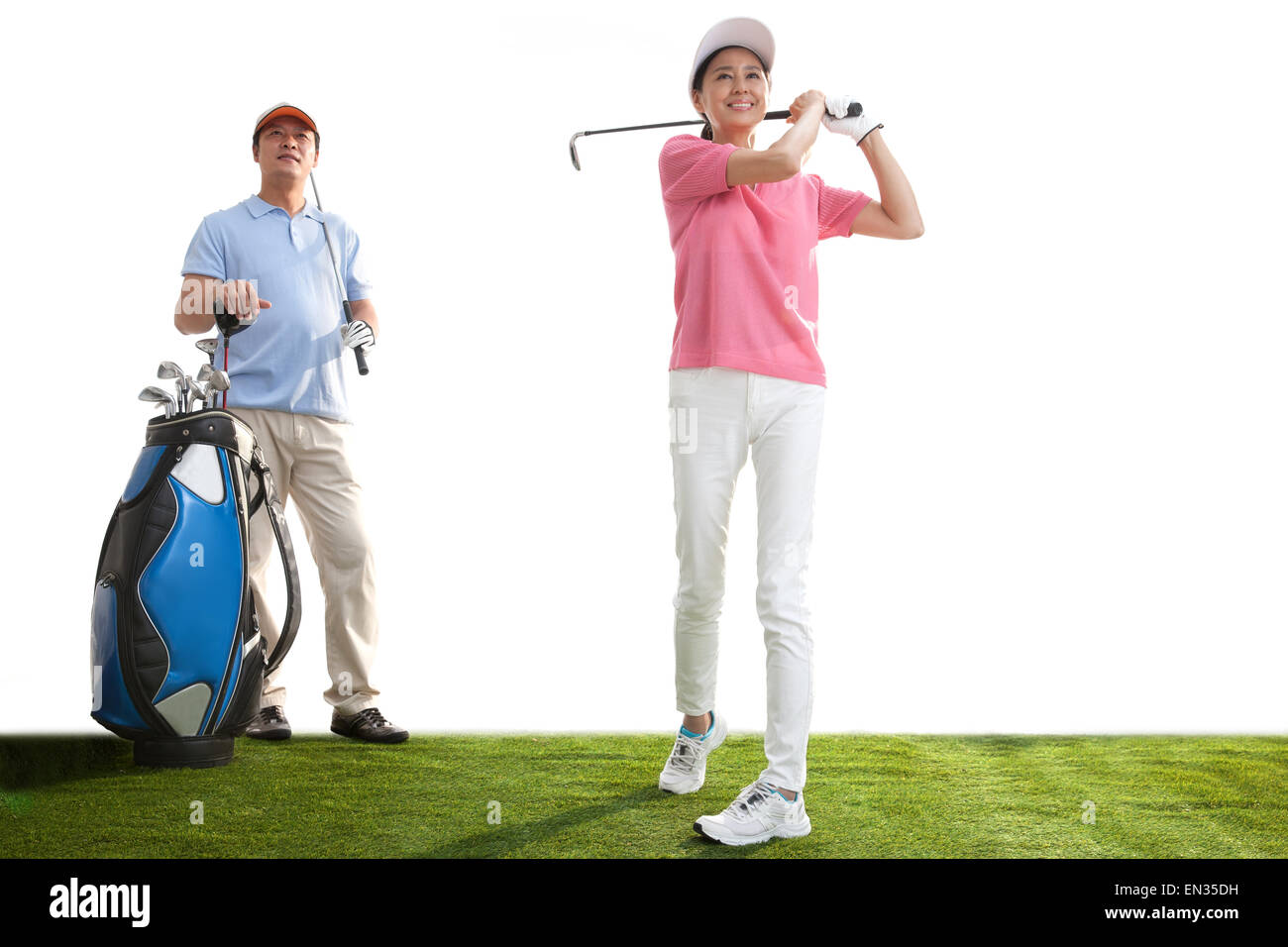 A middle-aged couple playing golf Stock Photo - Alamy