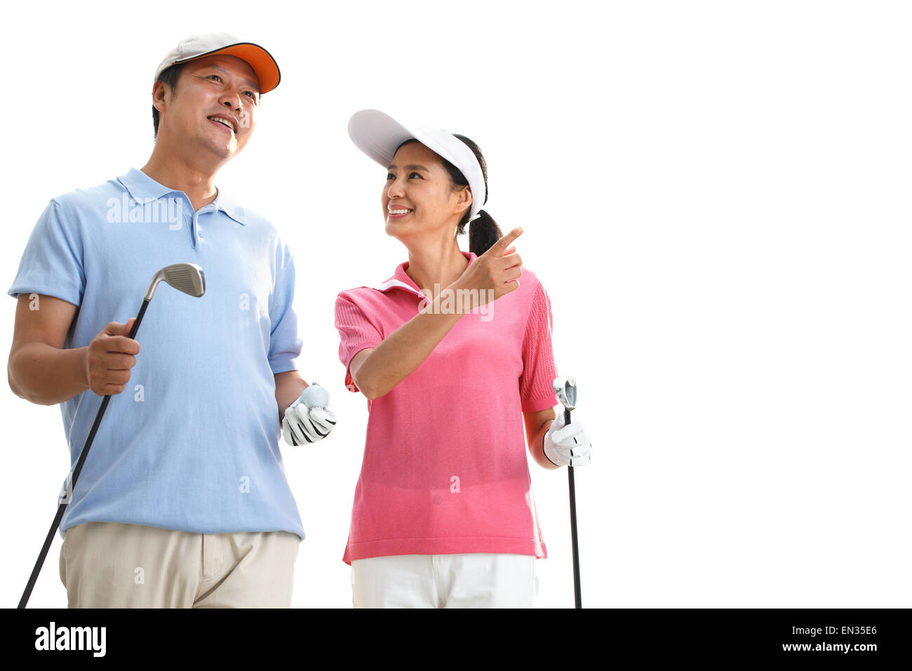 A middle-aged couple playing golf Stock Photo - Alamy