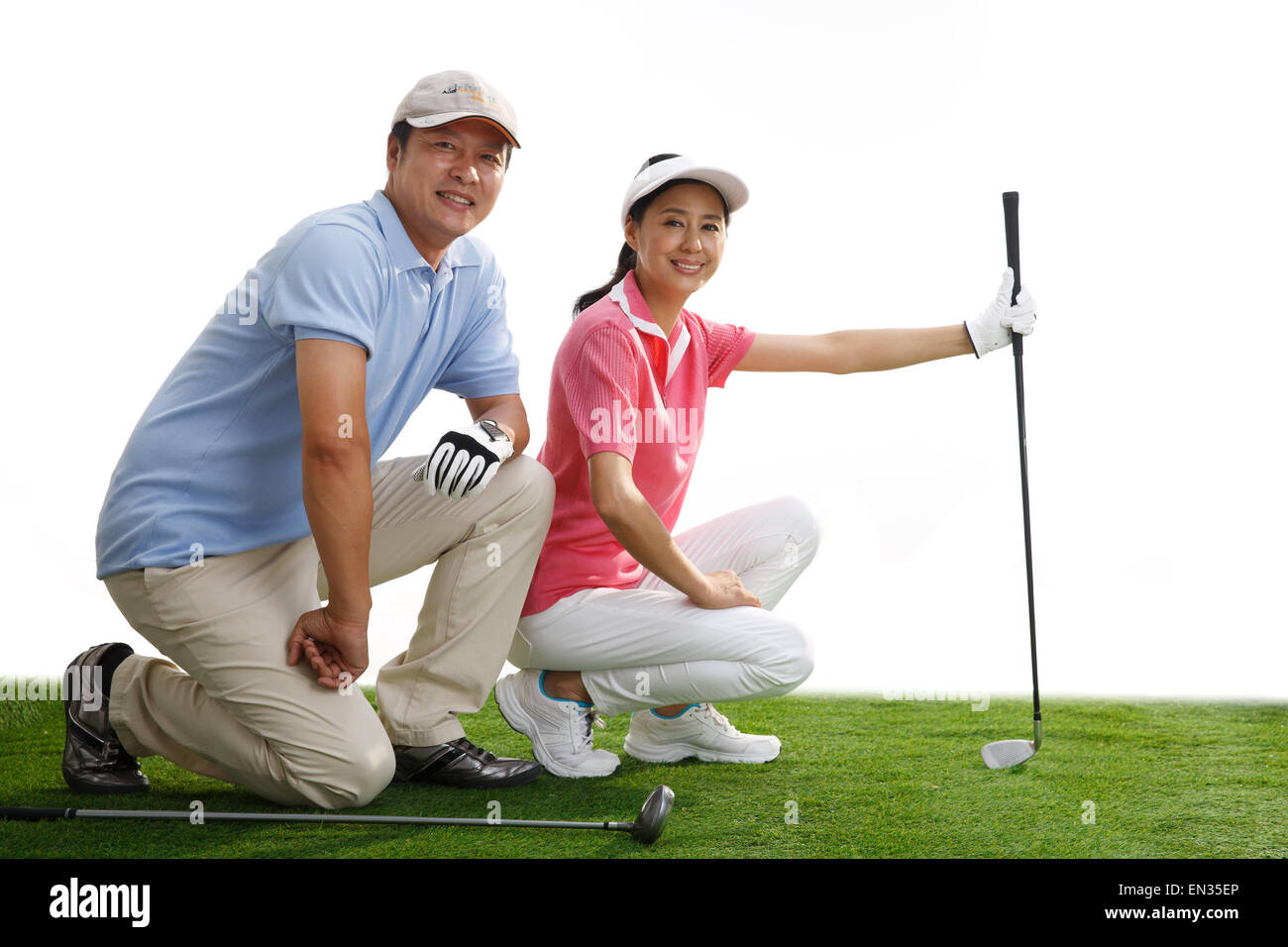 A middle-aged couple playing golf Stock Photo - Alamy
