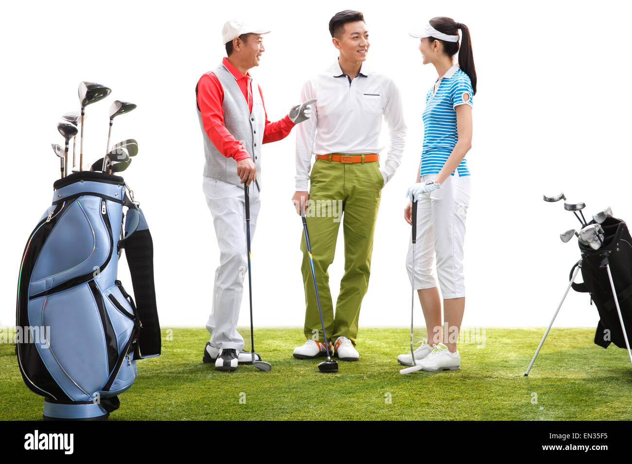 Young people playing golf Stock Photo - Alamy