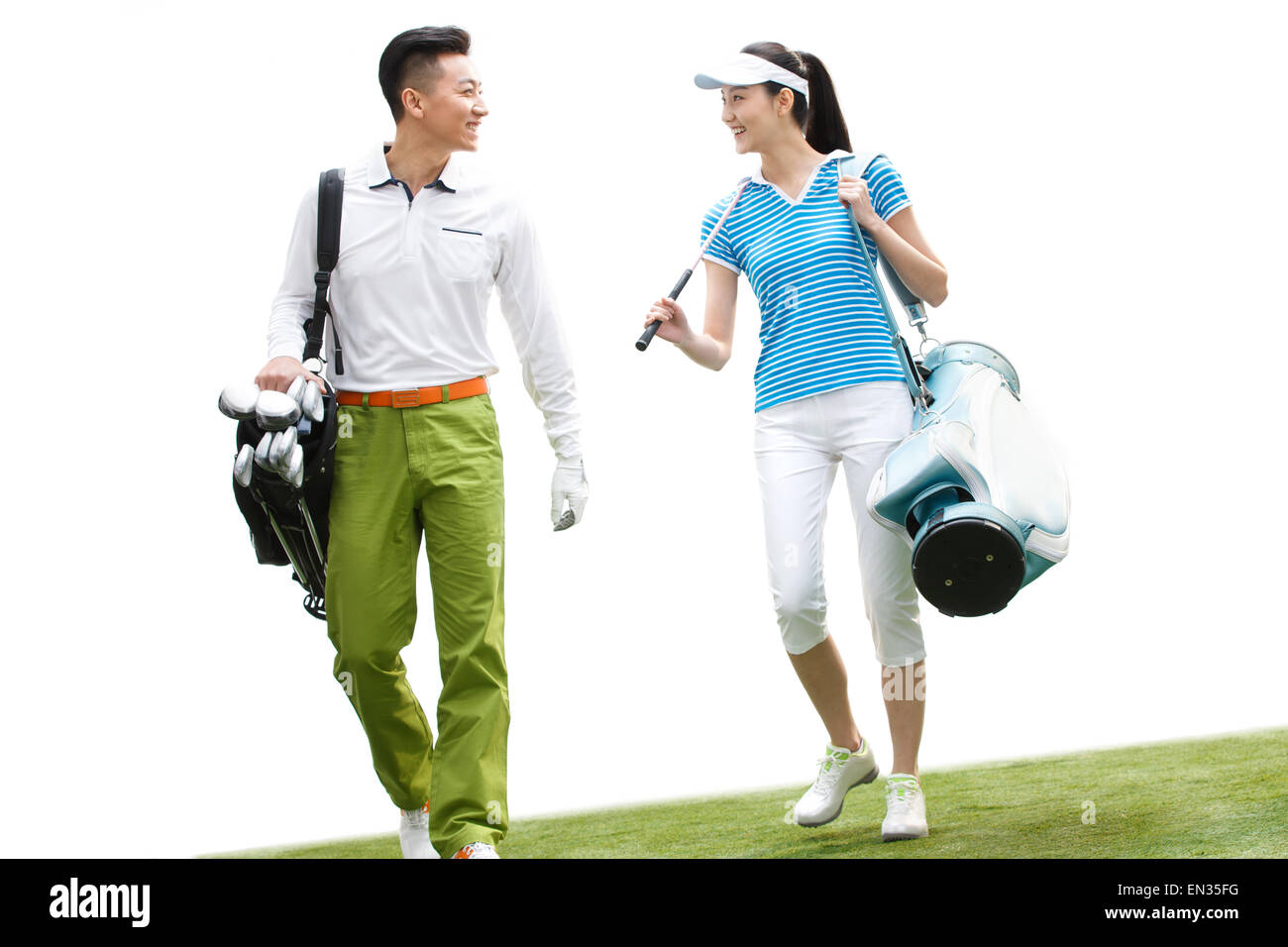 Young people playing golf Stock Photo - Alamy