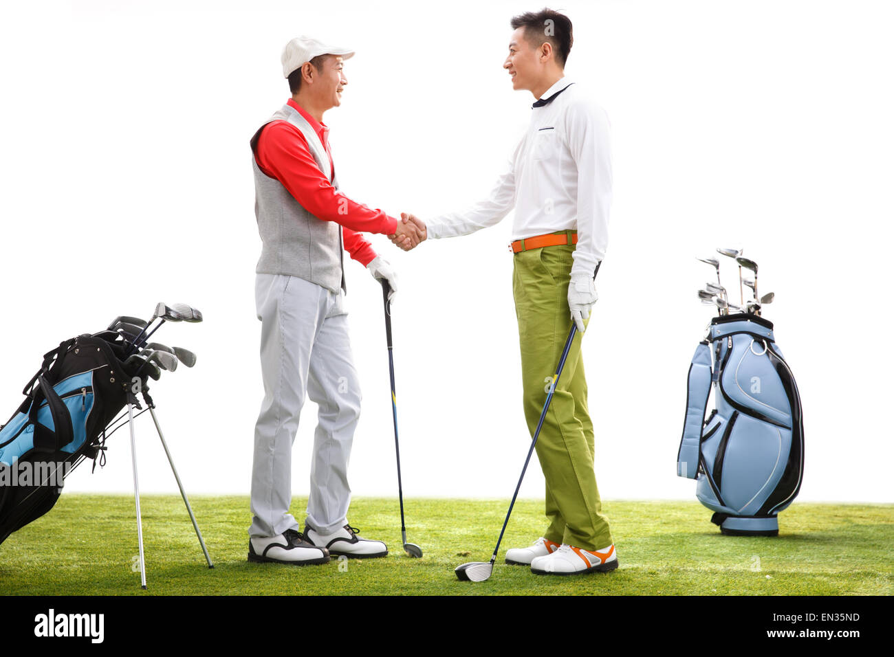 Two golf male players shake hands Stock Photo - Alamy