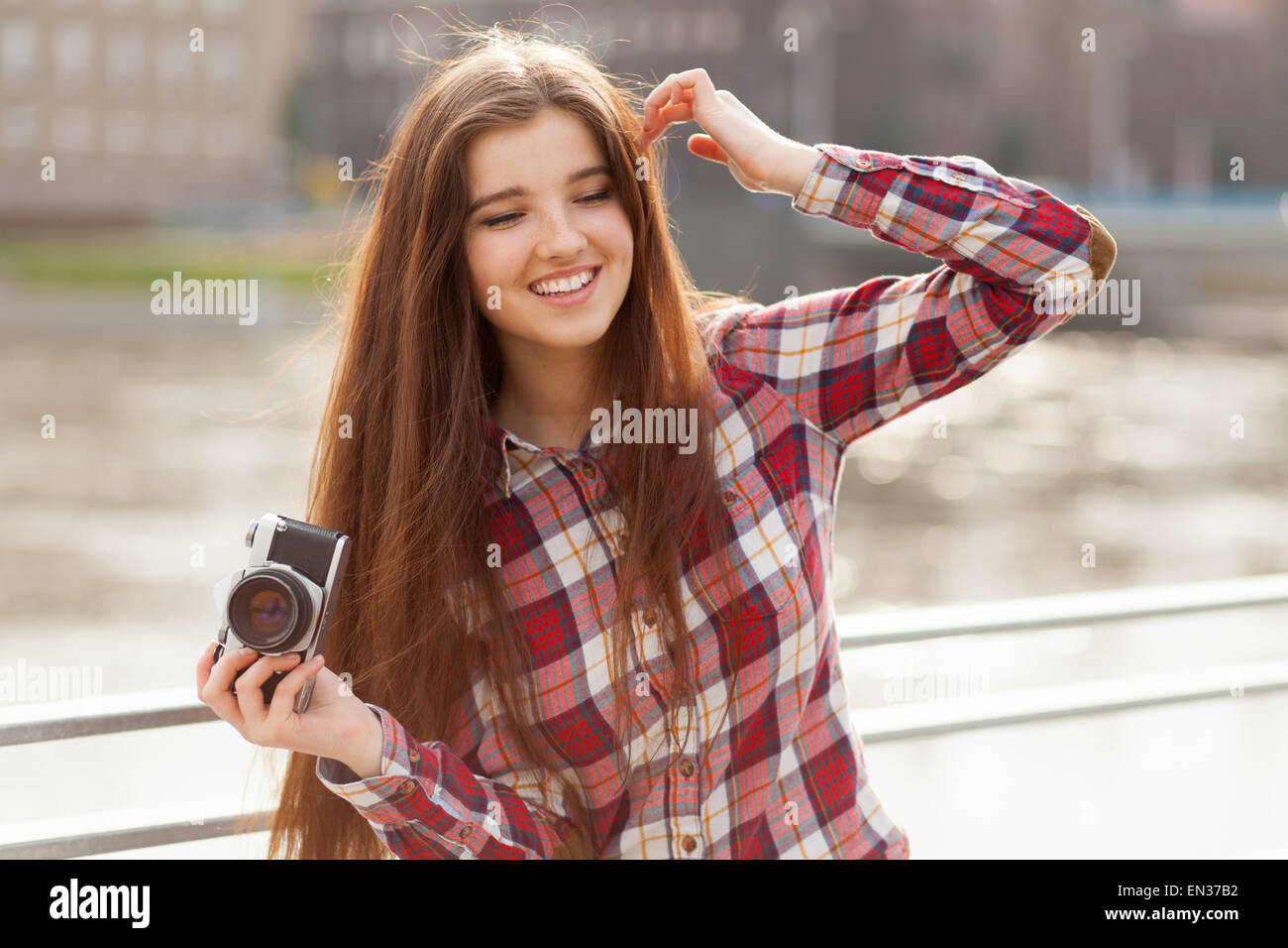 Portrait of a young woman with photo camera Stock Photo - Alamy