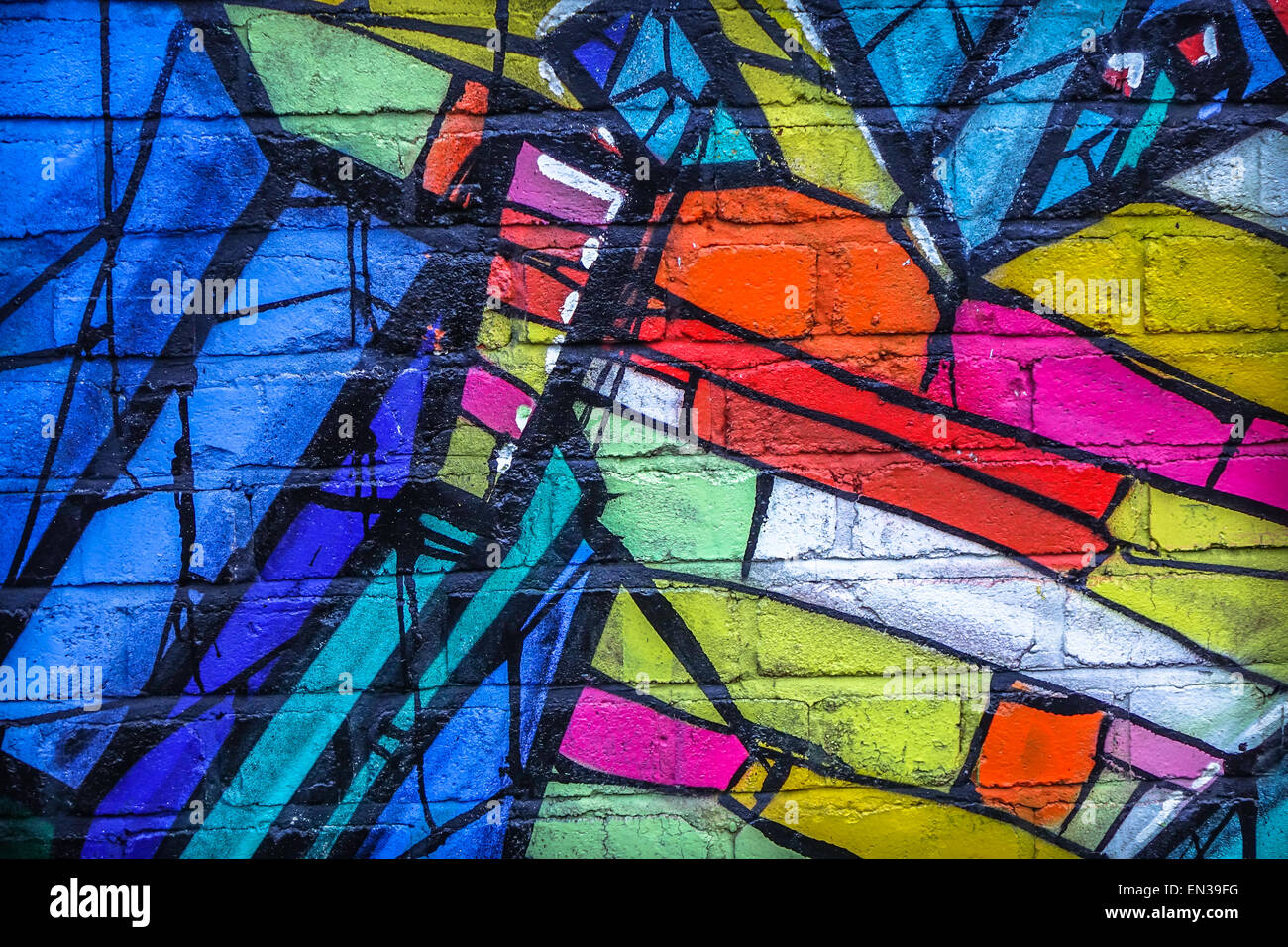 Abstract urban stained glass style graffiti on a brick wall Stock Photo ...