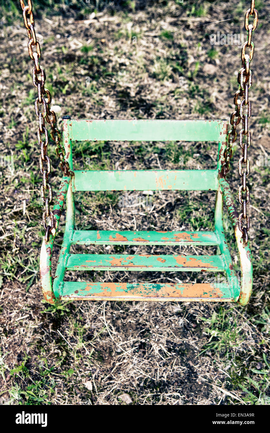 Old green rusty swing on playground Stock Photo - Alamy