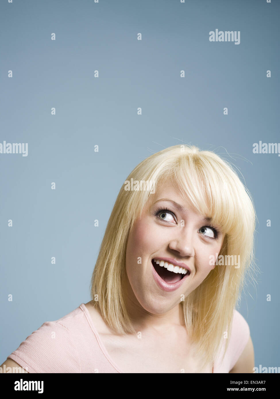 Woman looking up with mouth open smiling Stock Photo - Alamy
