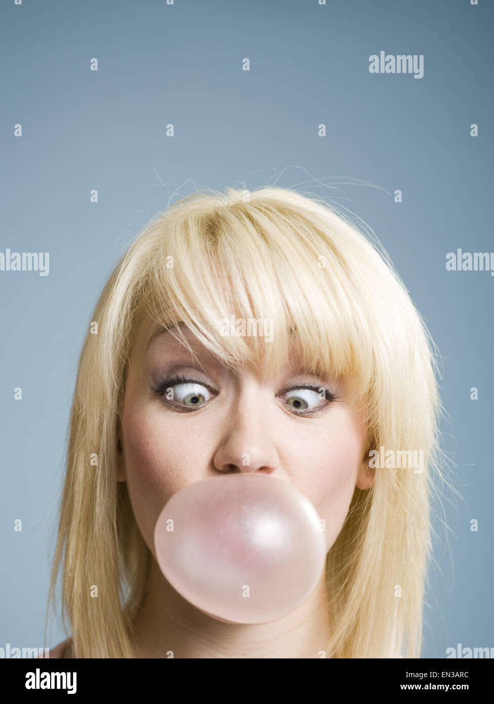 Woman blowing bubbles with chewing gum Stock Photo - Alamy