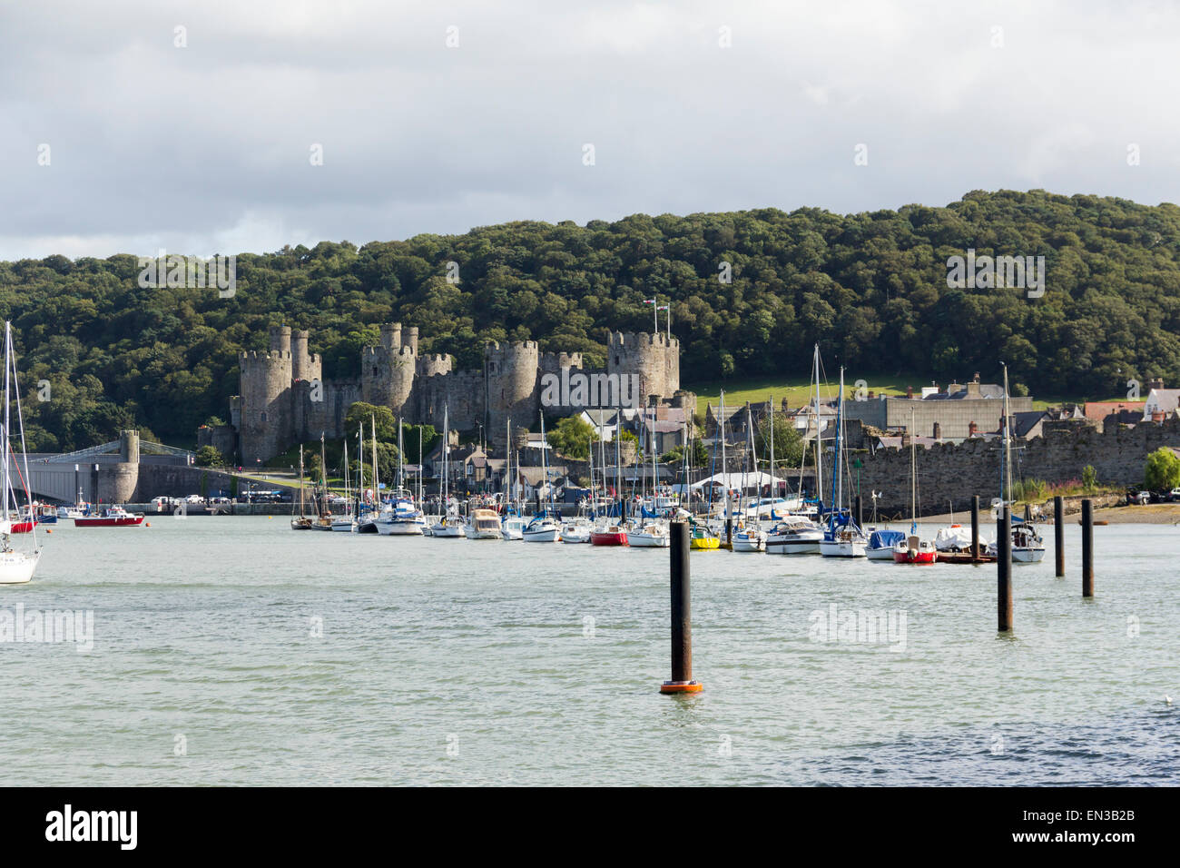 Conwy castle overlooking boats moored on the river Conwy. The medieval ...