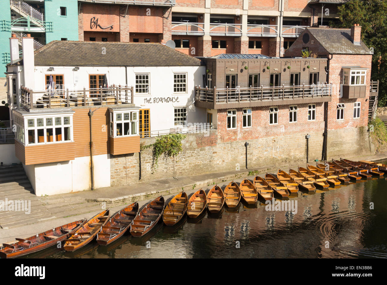 Rowing boats for hire, moored next to The Boathouse pub on the banks of ...