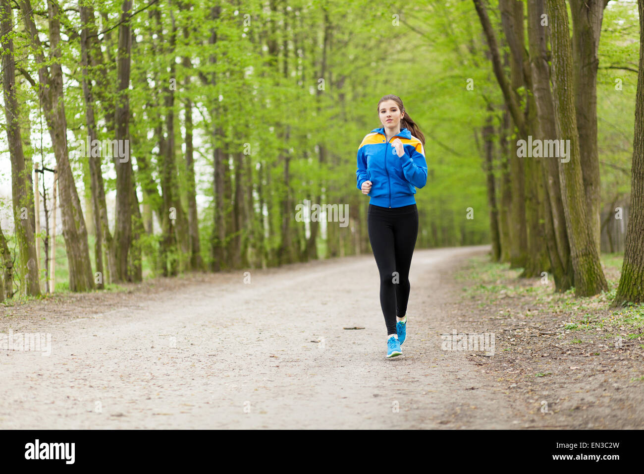 Young beautiful woman running on a trail Stock Photo - Alamy