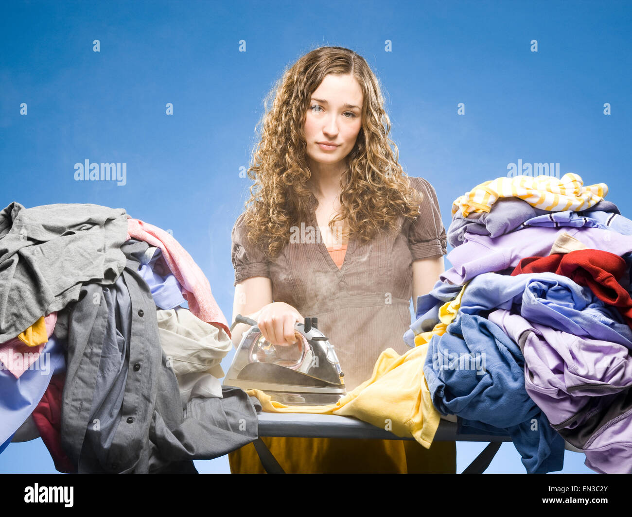 One woman overwhelmed pile of clothes hi-res stock photography and ...