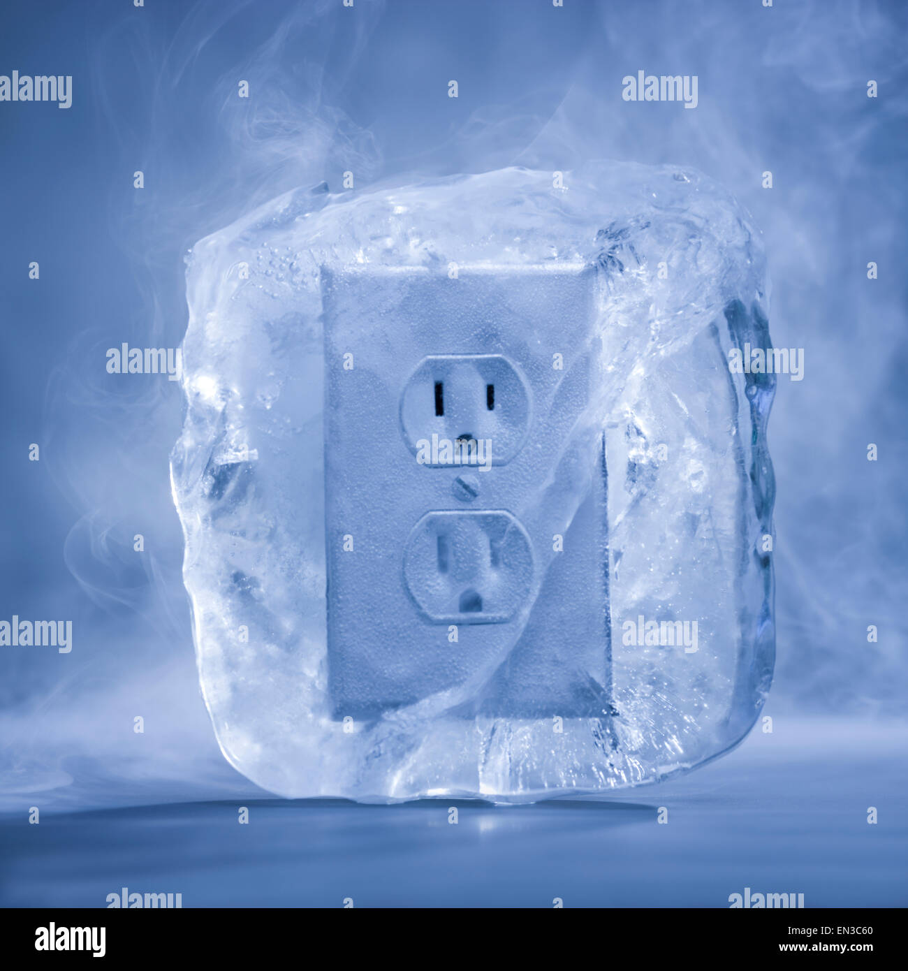 electrical outlet frozen in a block of ice Stock Photo - Alamy