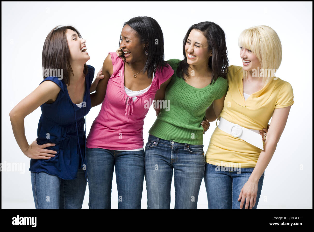 Four women hugging and smiling Stock Photo - Alamy