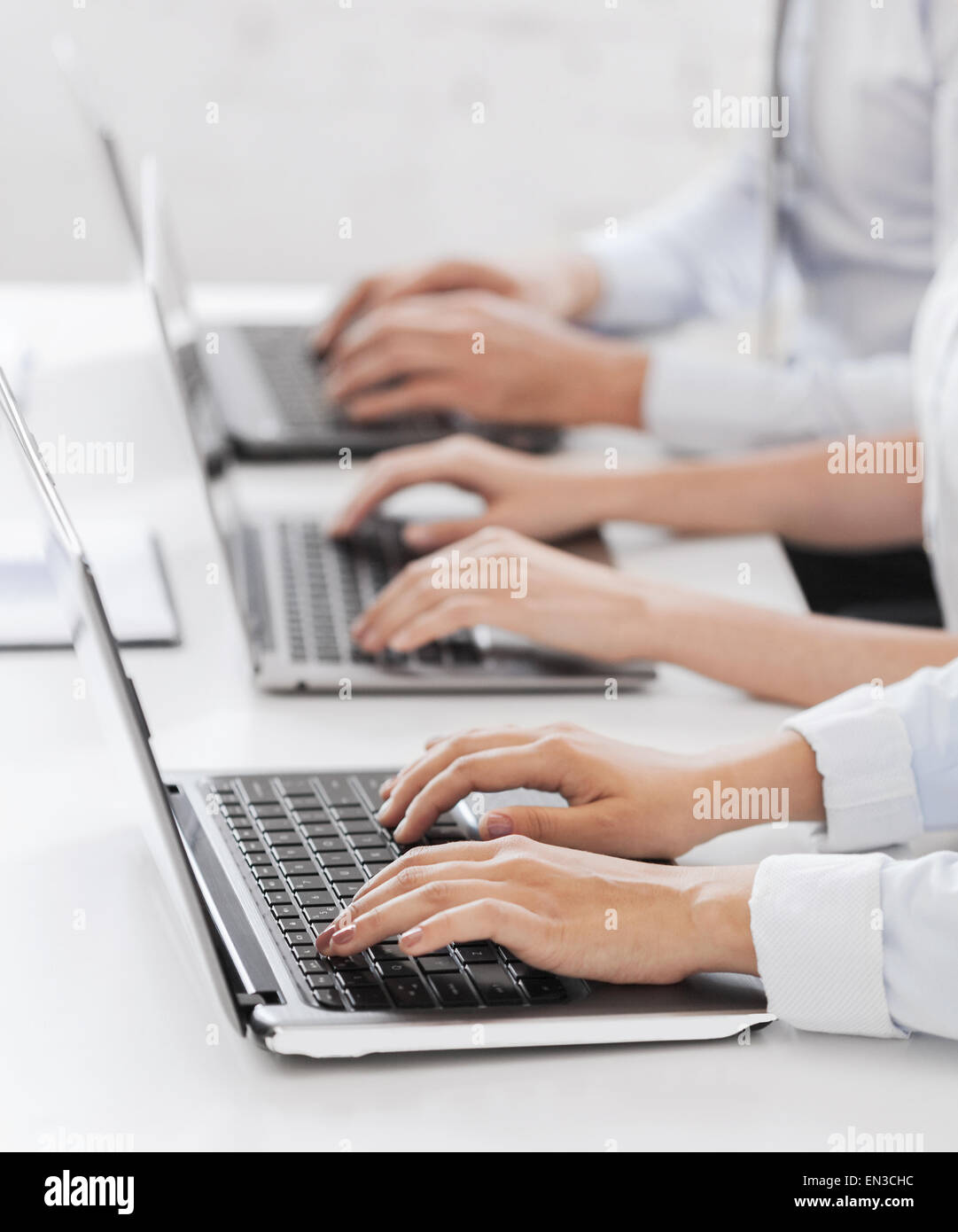 group of people working with laptops in office Stock Photo - Alamy