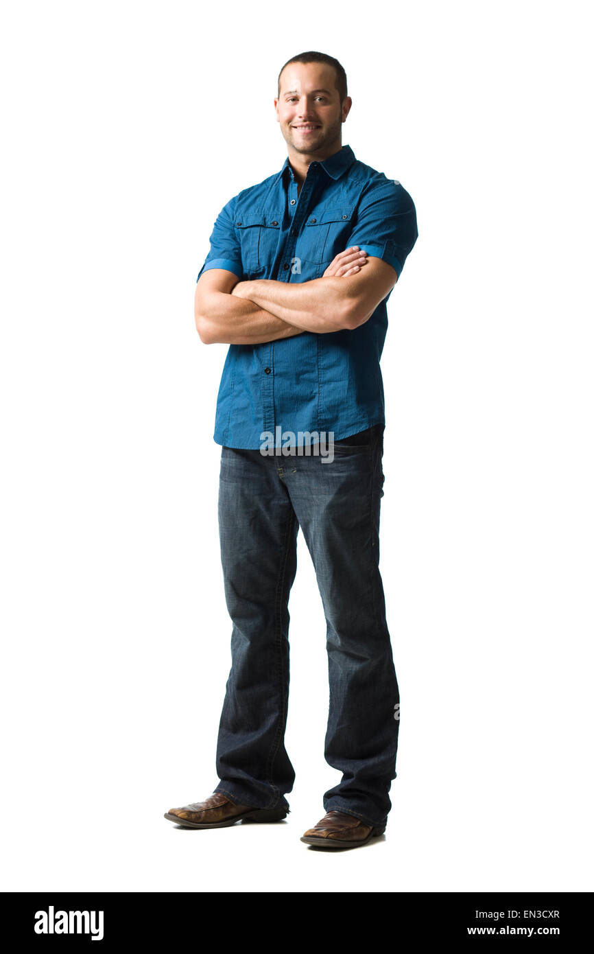 Studio portrait of smiling young man standing with arms crossed Stock ...