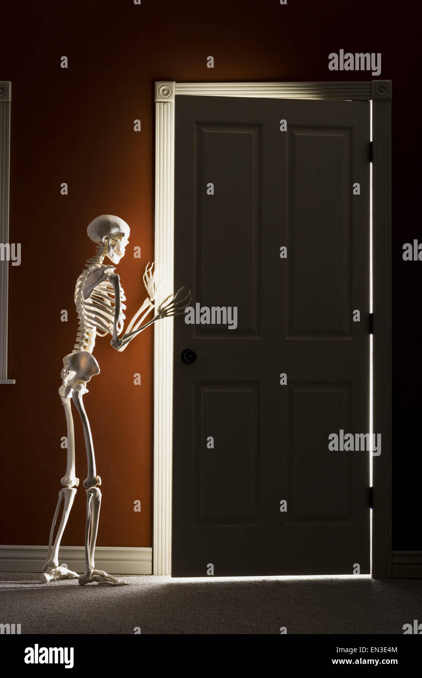 Skeleton opening door Stock Photo - Alamy