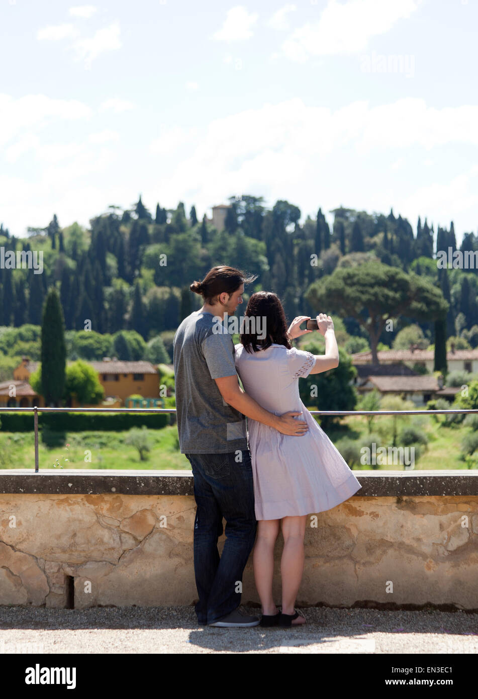 Italy, Florence, Young couple photographing rural landscape Stock Photo ...