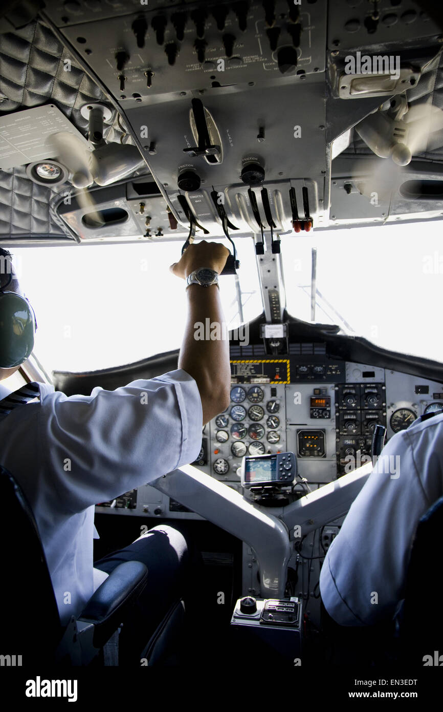 Rear view of a pilot operating the control panel in an airplane Stock ...