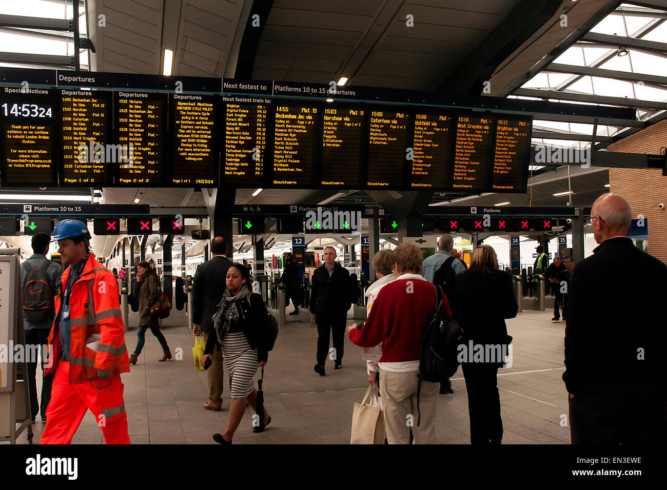 Train travel. People looking at train departure board at Waterloo train ...