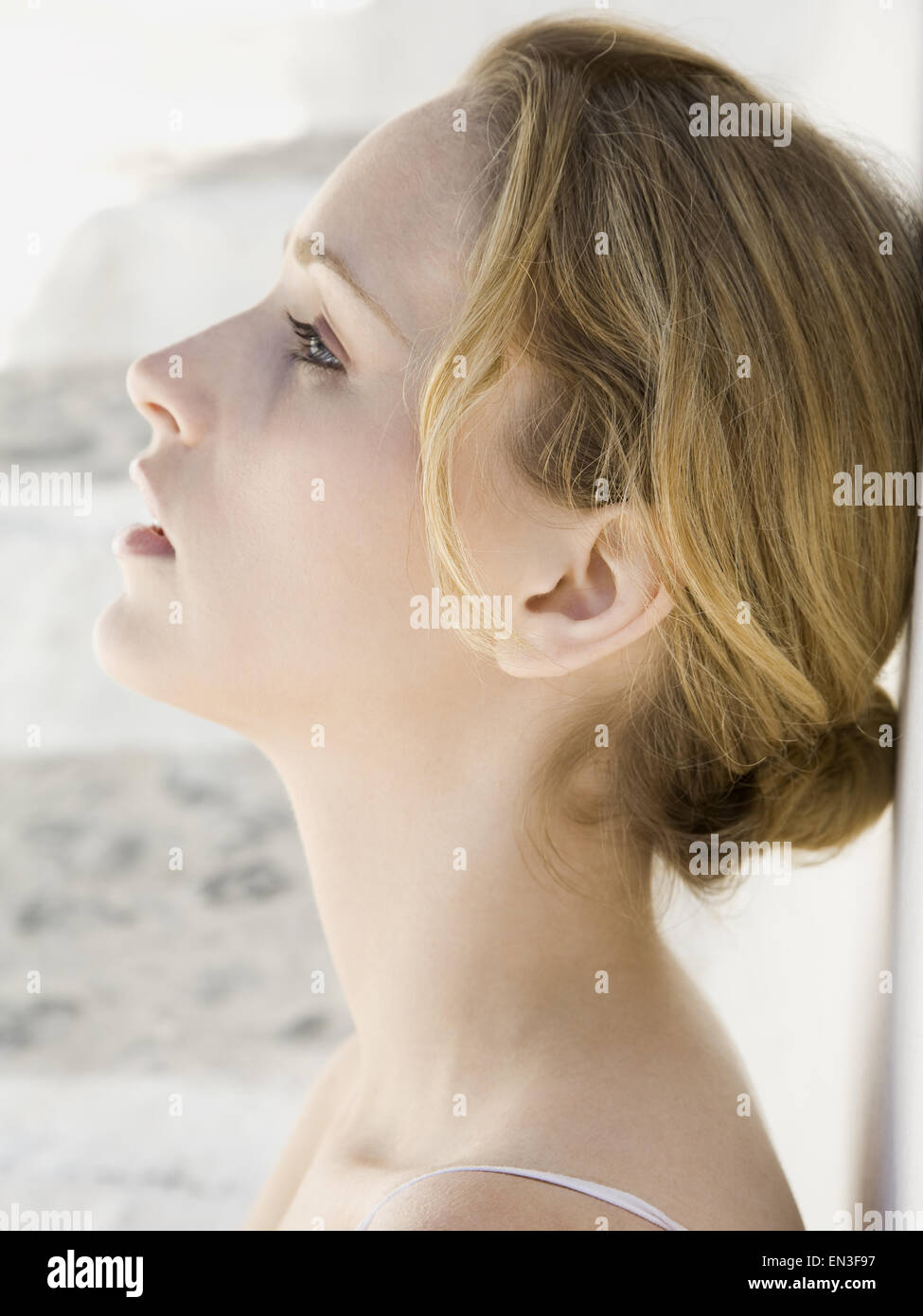 Closeup profile of woman leaning on wall Stock Photo - Alamy