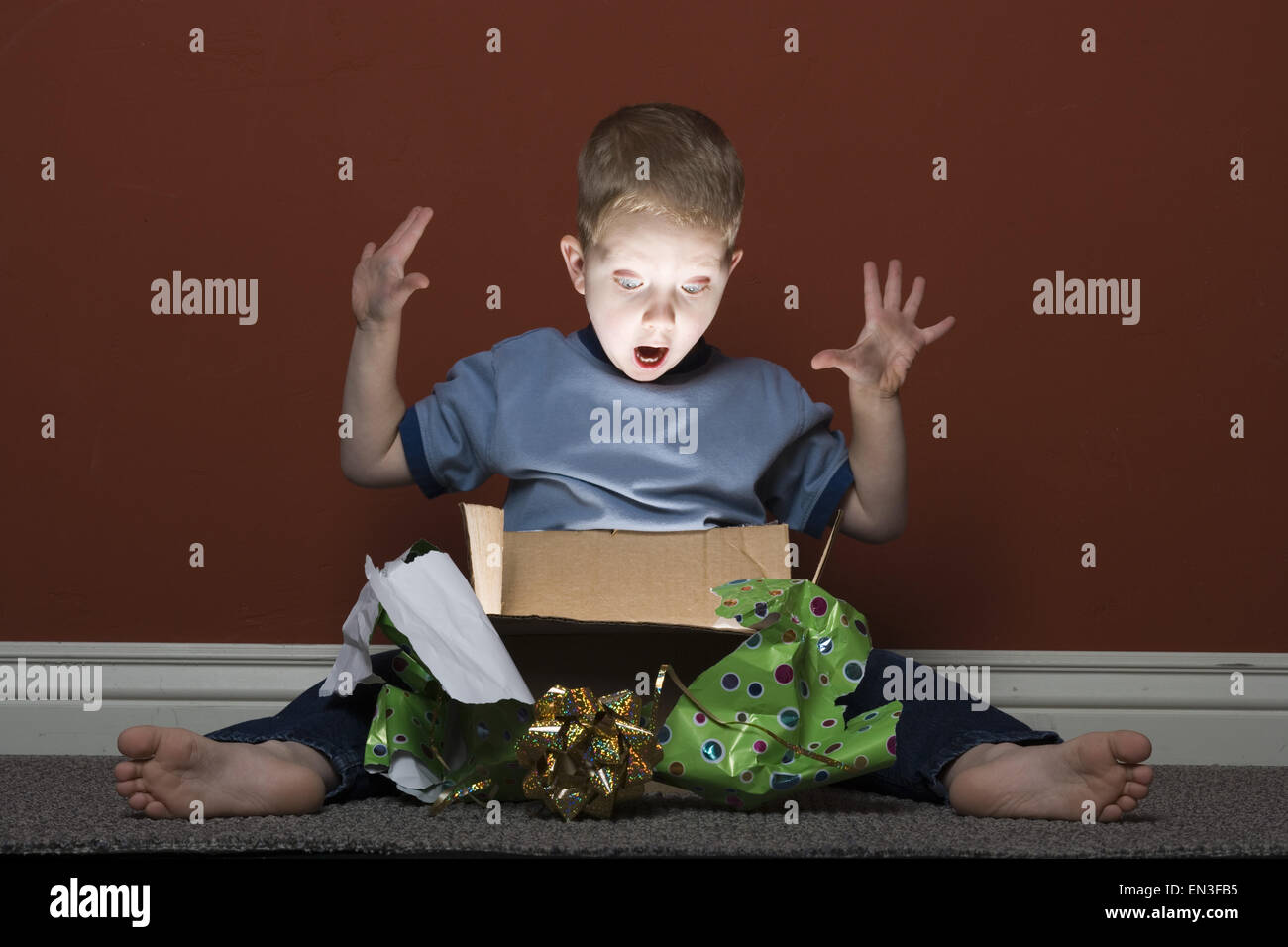 Young boy opening present Stock Photo - Alamy
