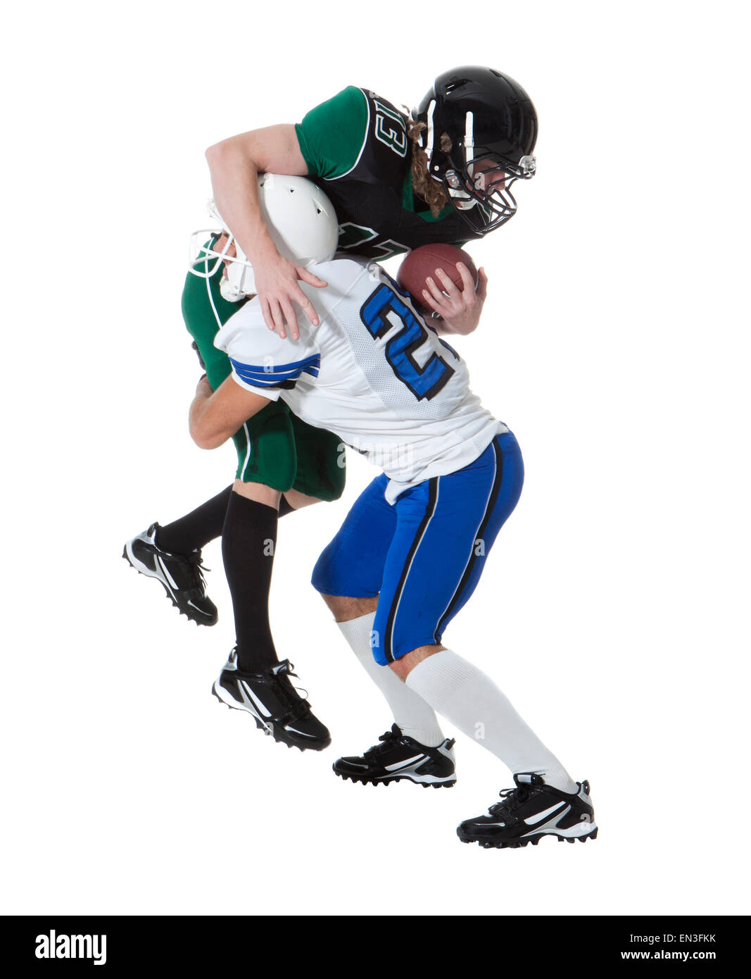 Two male players of American football fighting for ball, studio shot ...