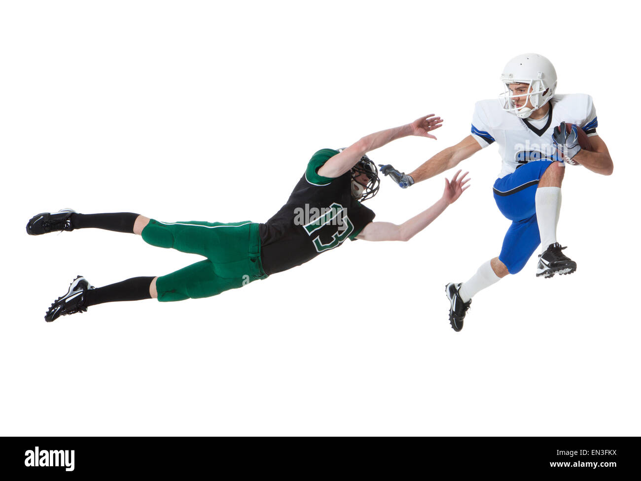 Two male players of American football fighting for ball, studio shot ...