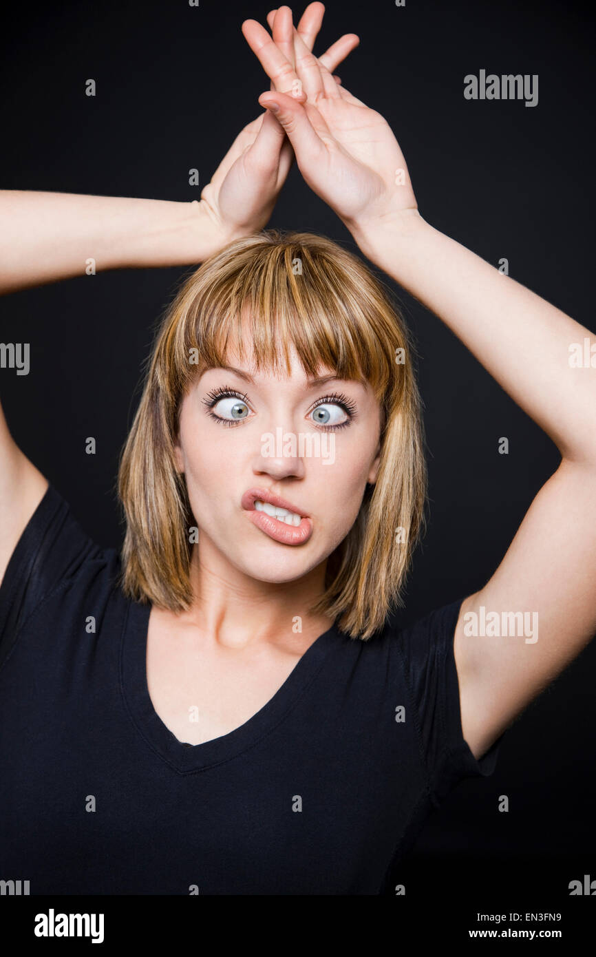 Young woman pulling funny faces Stock Photo - Alamy