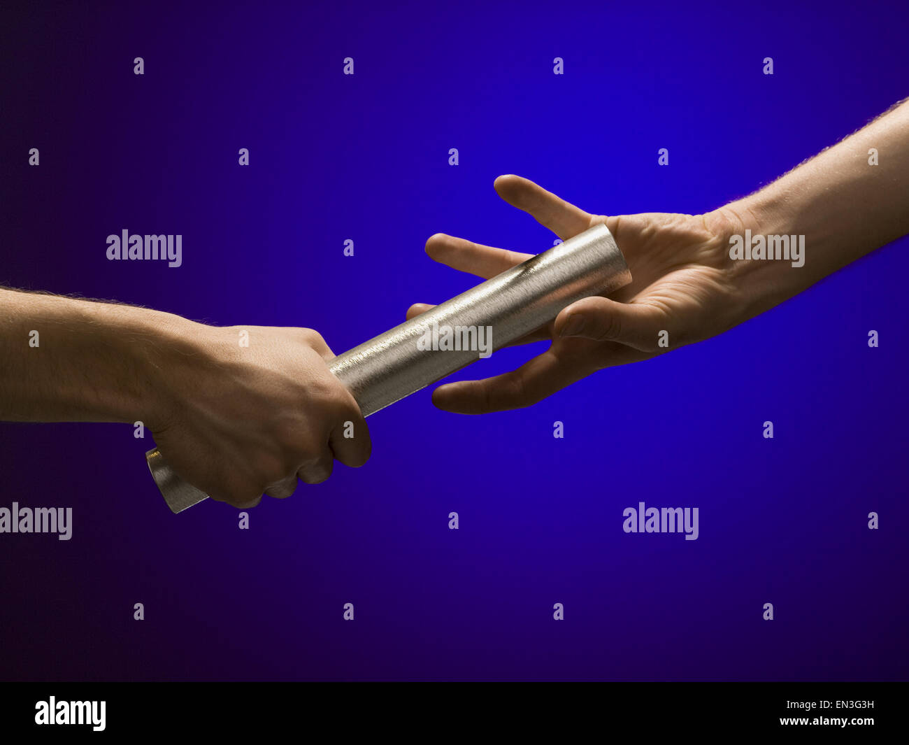 Closeup of relay baton being passed Stock Photo - Alamy