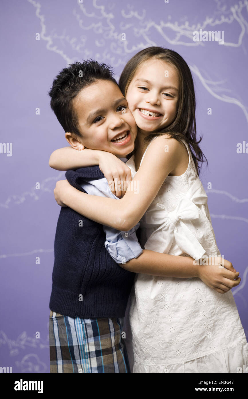 Young girl and boy hugging Stock Photo - Alamy