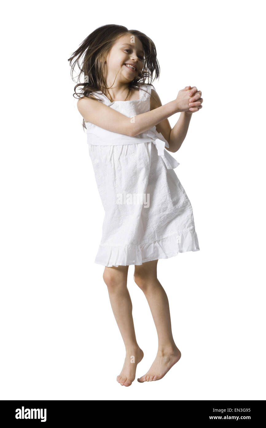 Girl in white dress dancing Stock Photo - Alamy