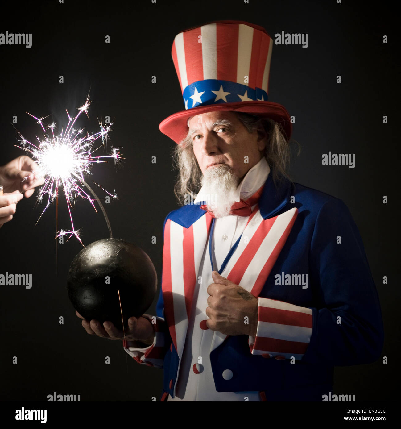 Studio portrait of Uncle Sam holding bomb Stock Photo - Alamy