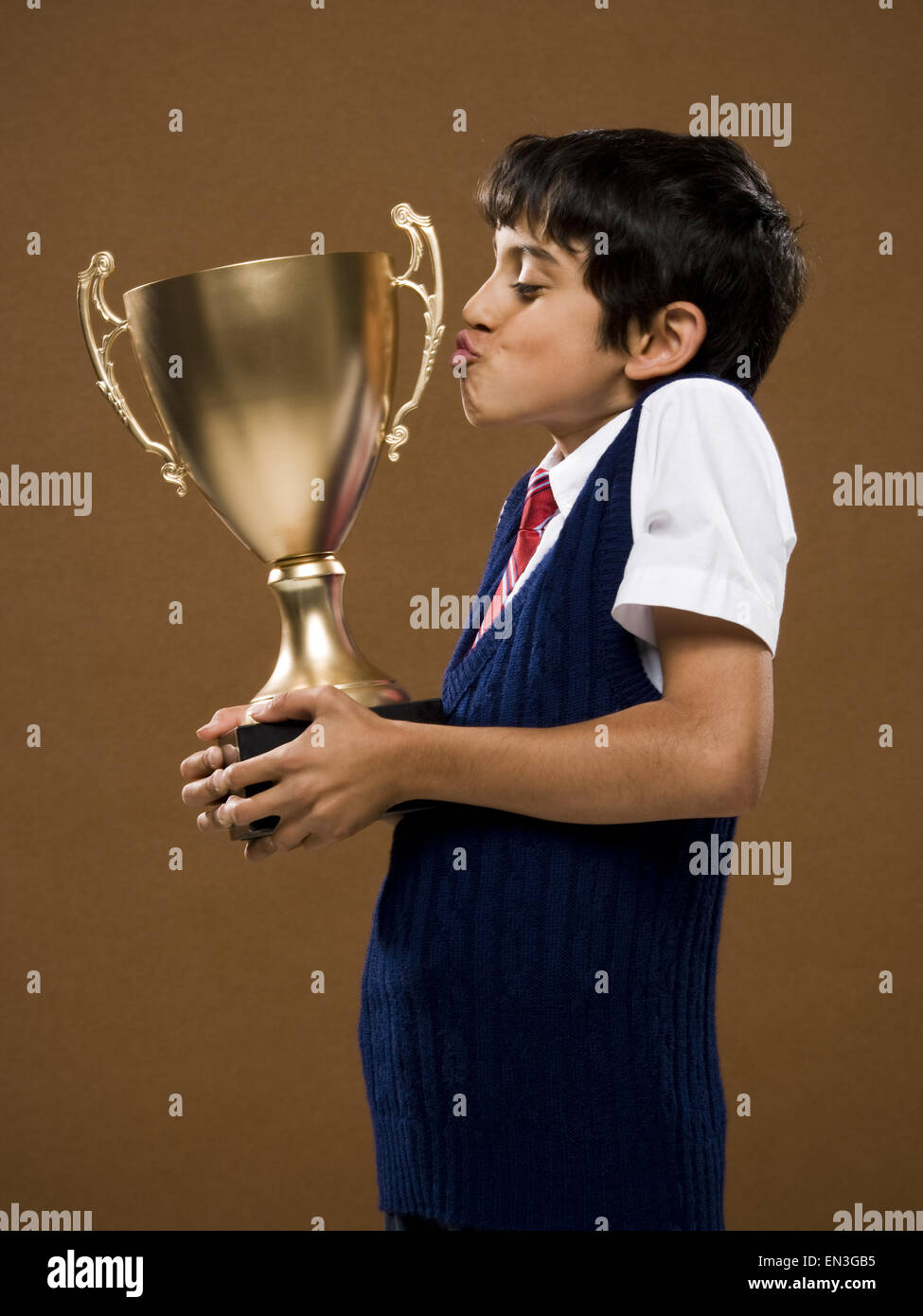 Boy kissing trophy cup Stock Photo - Alamy