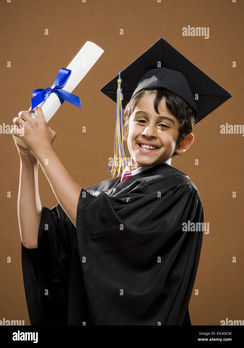 Boy graduate with mortar board and diploma smiling Stock Photo - Alamy