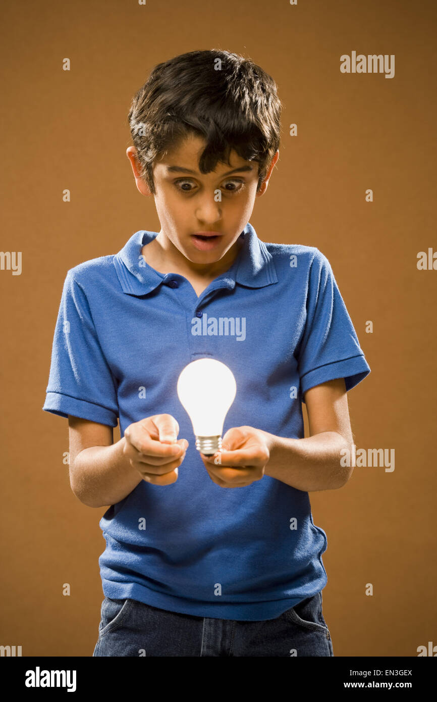 Boy with lightbulb and wire Stock Photo - Alamy