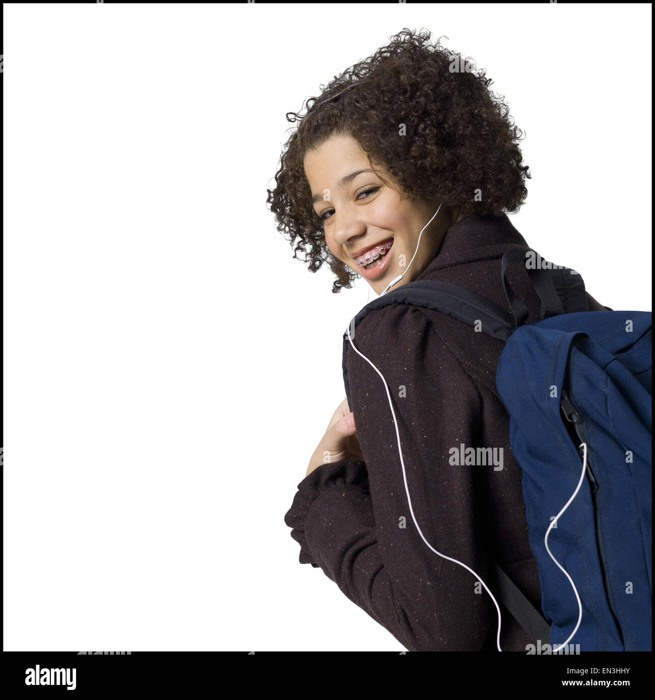 Girl with backpack and earbuds smiling with braces Stock Photo - Alamy