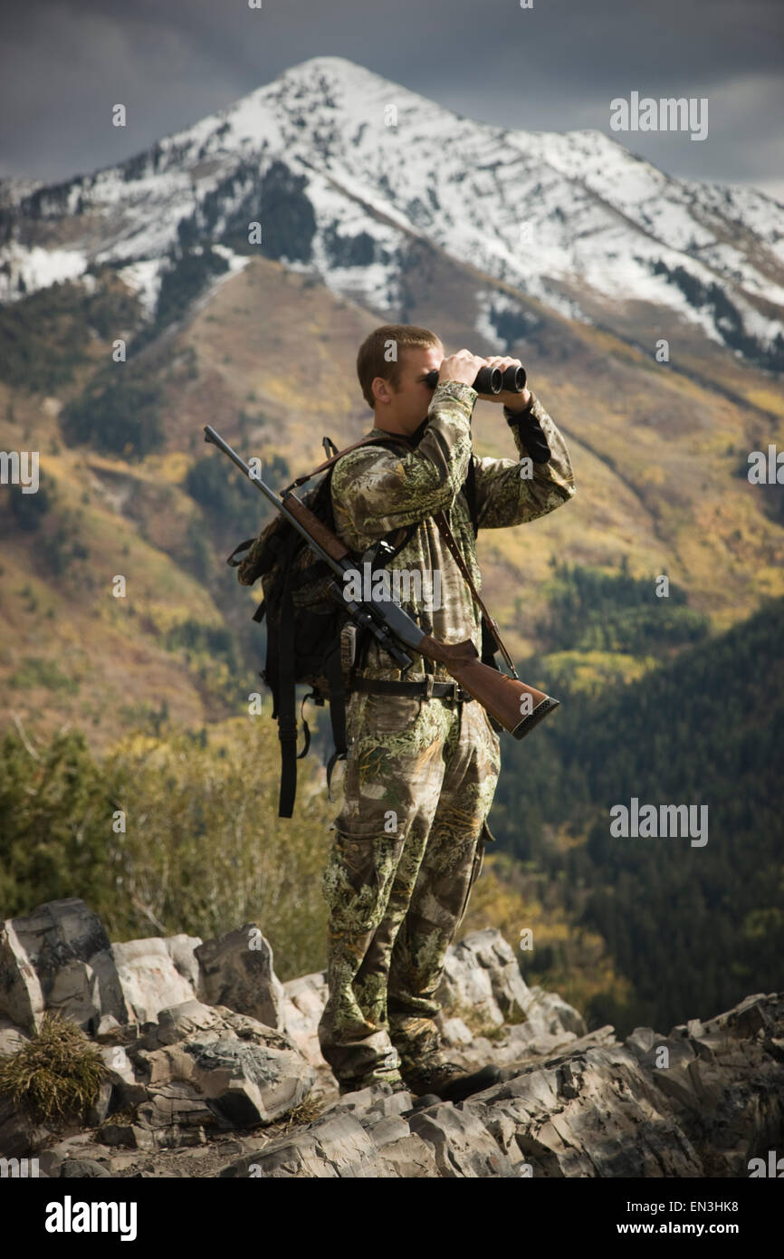 hunter using binoculars to spot prey Stock Photo - Alamy