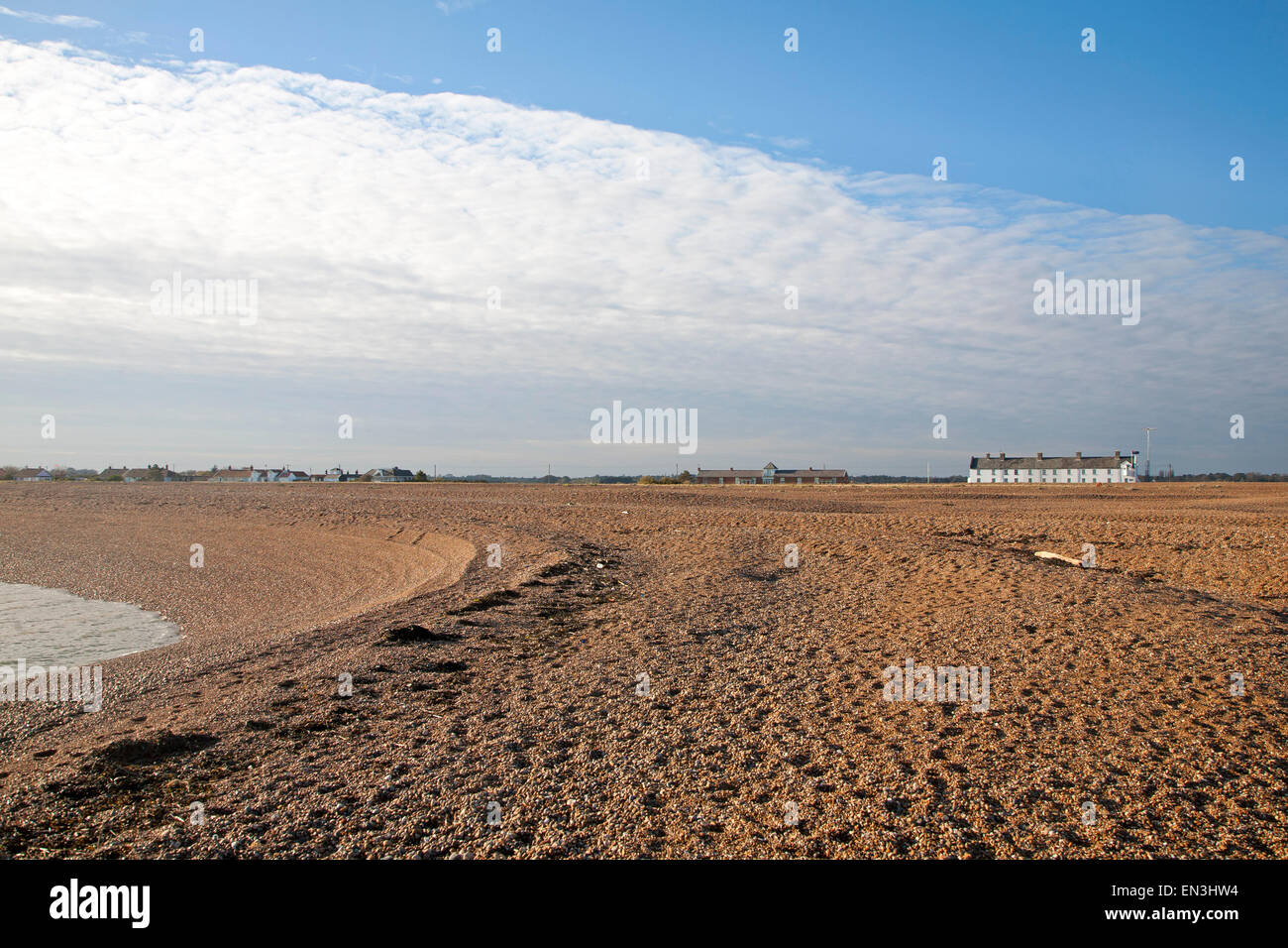 Frontal clouds passing over Coastguard Cottages shingle beach at ...