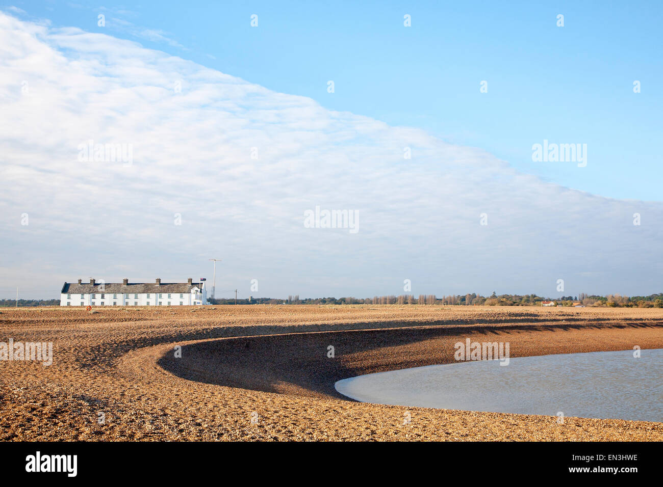 Frontal clouds passing over Coastguard Cottages shingle beach at ...